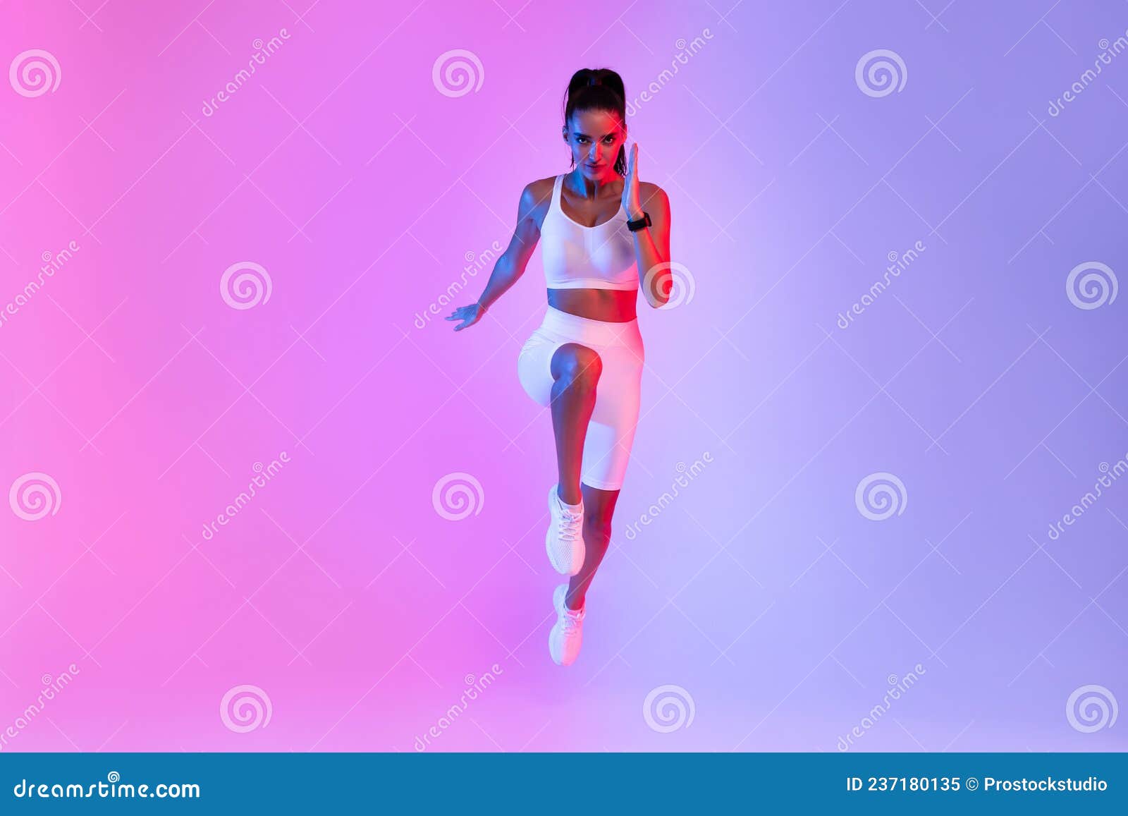 Front-View of Female Running Looking at Camera Over Neon Background ...