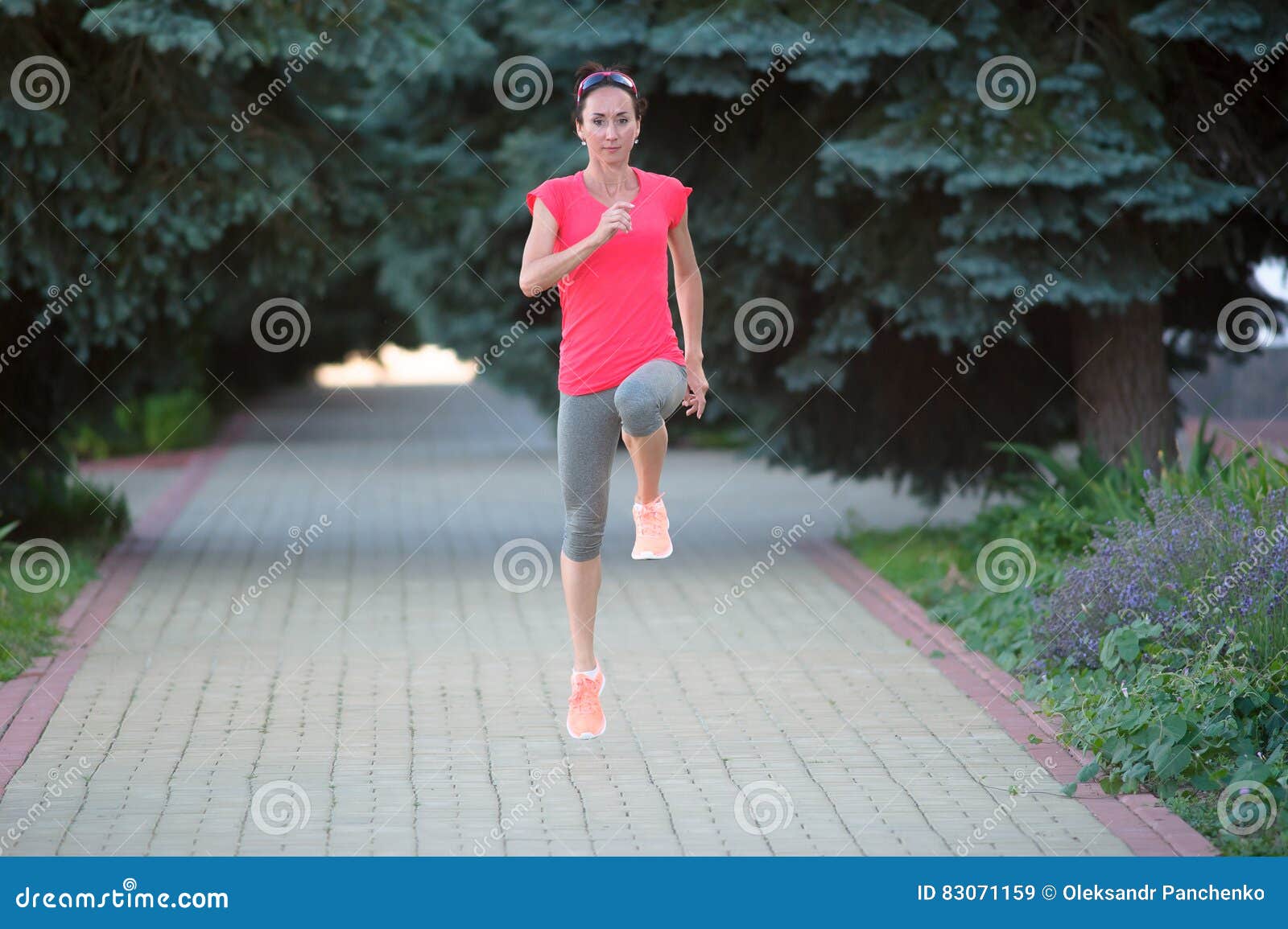 Front View of a Girl Doing Exercise Outdoor in a Park, Jogging Stock ...