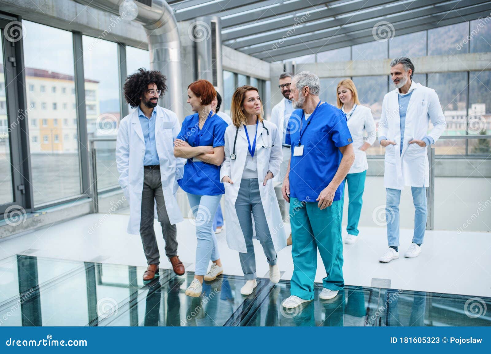 Front View of Group of Doctors Walking in Corridor on Conference. Stock ...