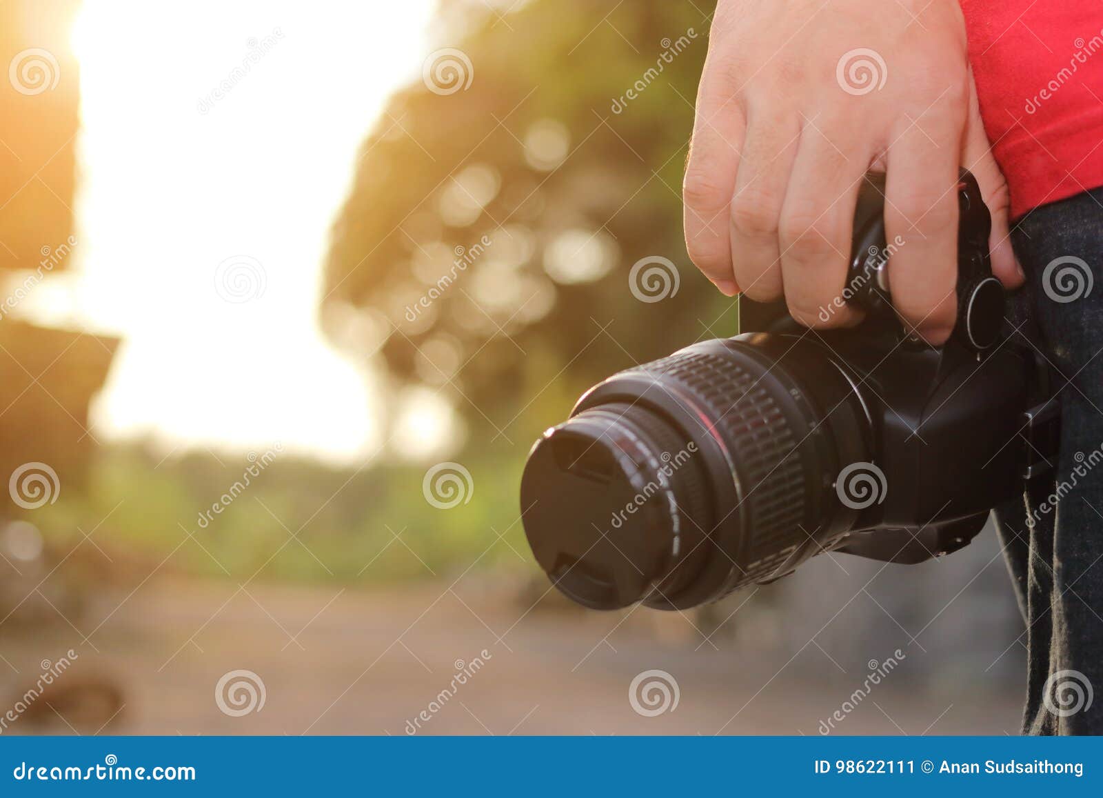 Front View of Hands of Young Photographer Holding Camera with Sunshine ...