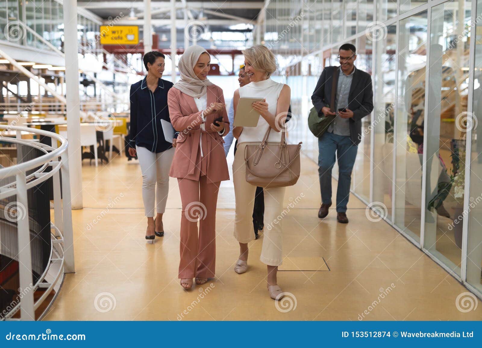 Business People Interacting with Each Other while Walking in a Modern ... Business People Interacting with Each Other while Walking in a Modern ...
