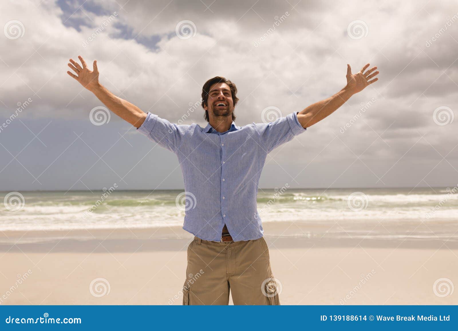 Man Standing with Arms Outstretched on the Beach Stock Photo - Image of ...