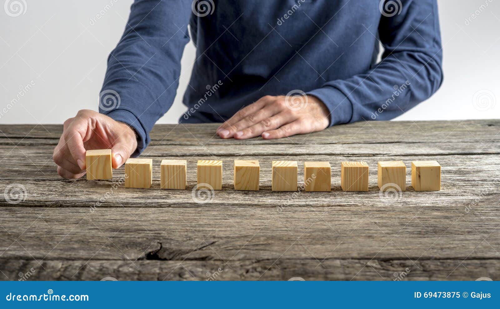 Front View of a Man Placing Ten Wooden Cubes in a Row Stock Image ...