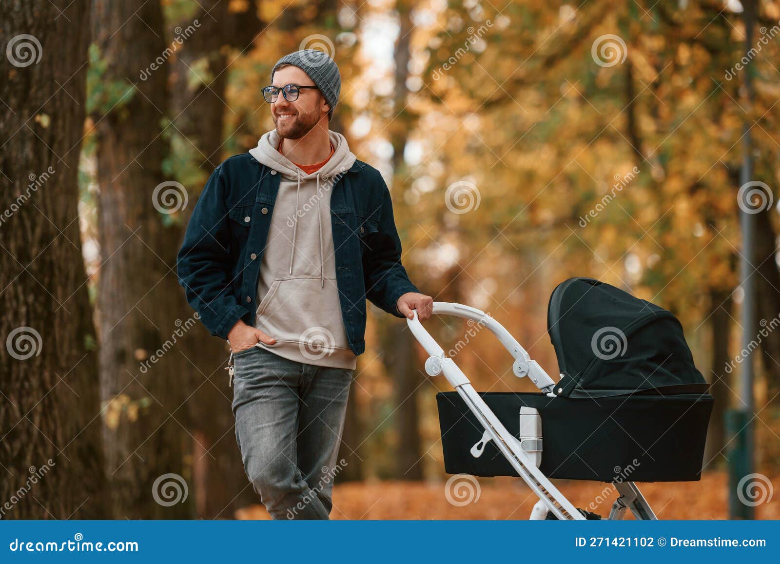 Front View. Man with Pram is Having a Walk in the Autumn Park Stock ...