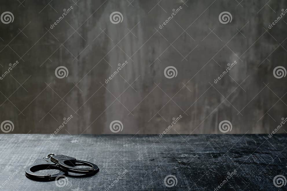 Front View of Metal Handcuffs on Table in Interrogation Room Stock ...