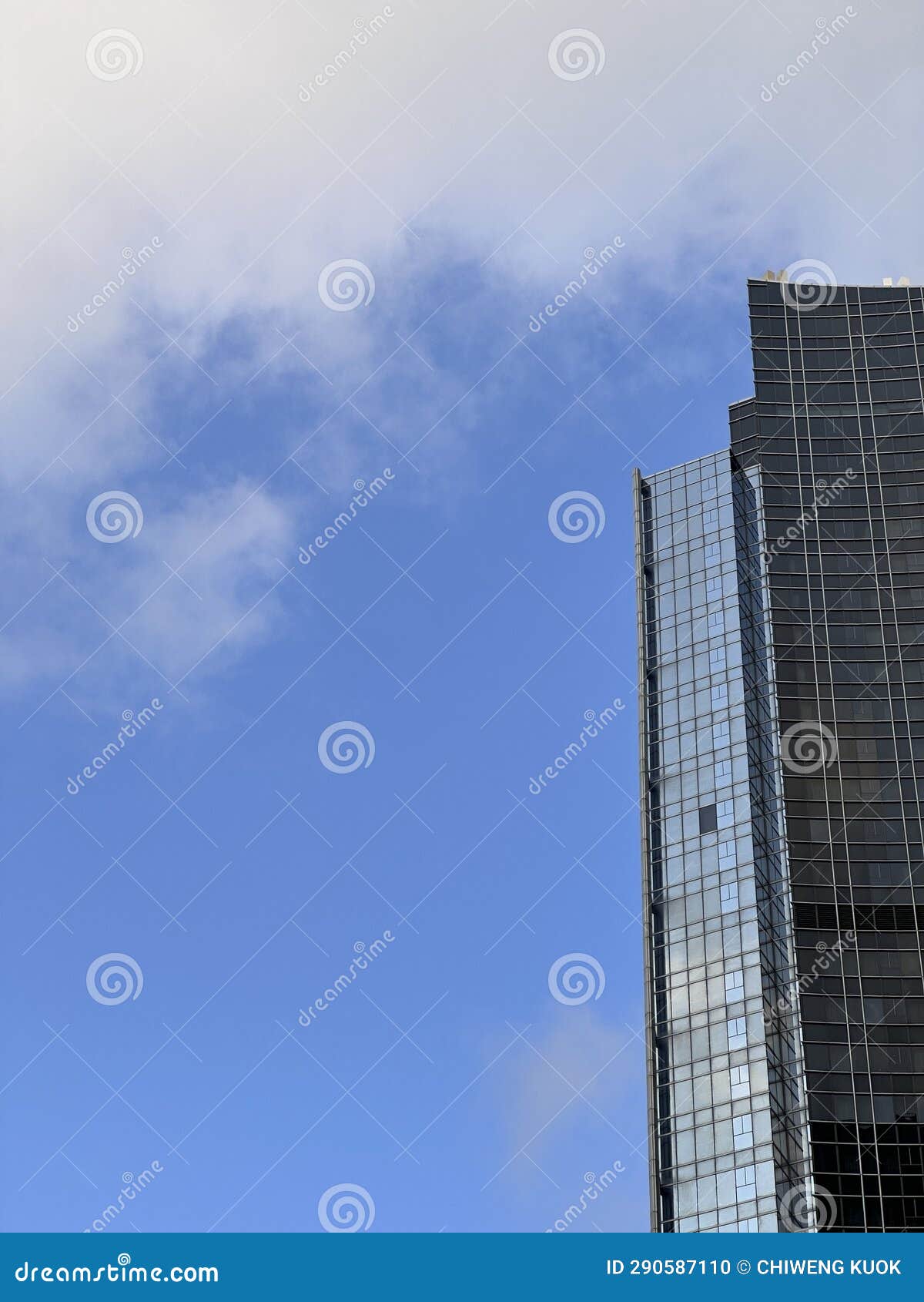 Front View of a Modern Skyscraper with Blue Sky, Clouds and Copy Space ...