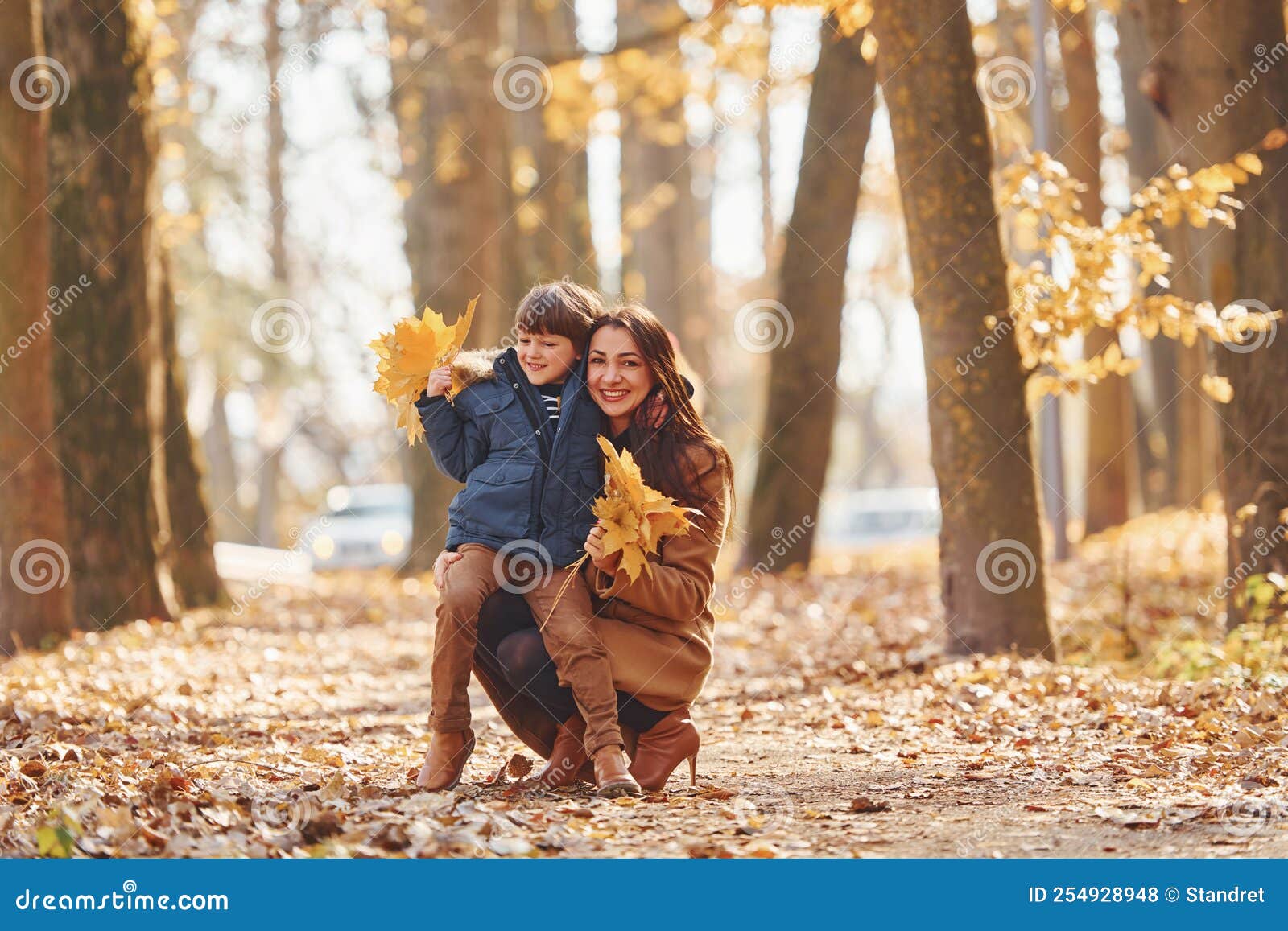 Front View Mother With Her Son Is Having Fun Outdoors In The Autumn