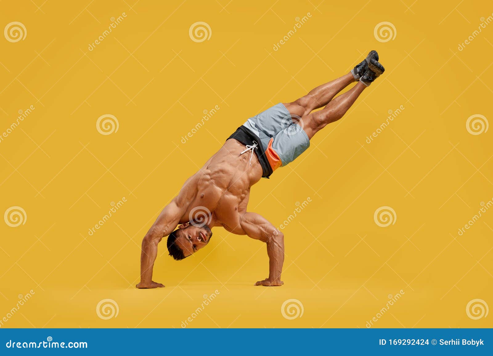 Athletic Young Man Performing Handstand Stunt Stock Photo - Image of ...