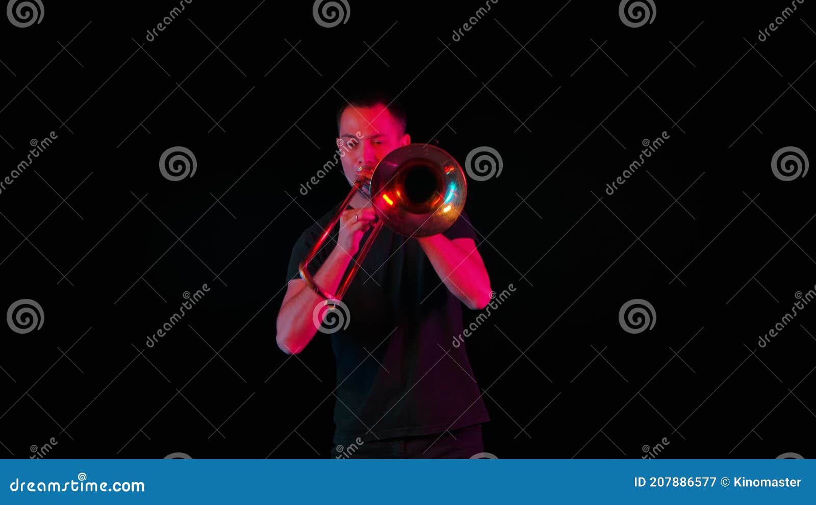 Front View of a Musician Playing the Trombone in the Studio Against a ...