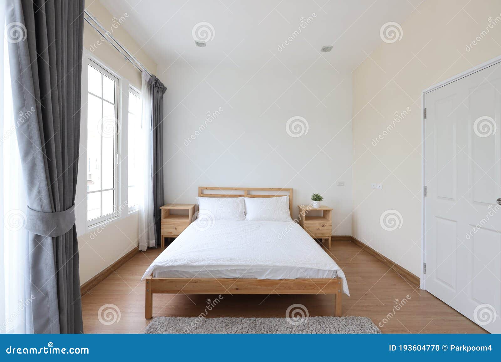 Front View of New Modern White Wooden Bed in White Bedroom with Soft ...