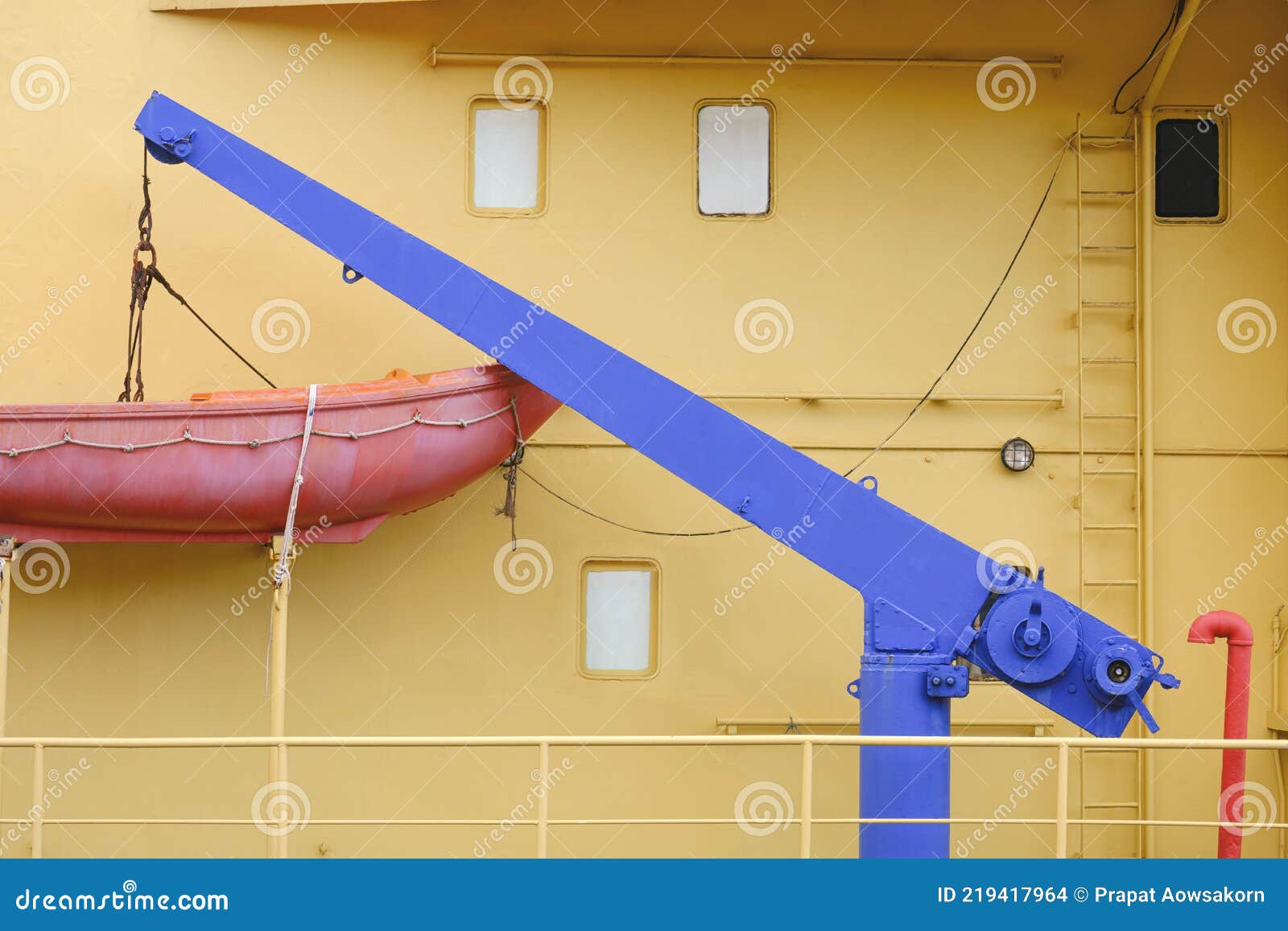Red Lifeboat with Small Blue Crane Boom on Side of Cargo Ship Stock ...