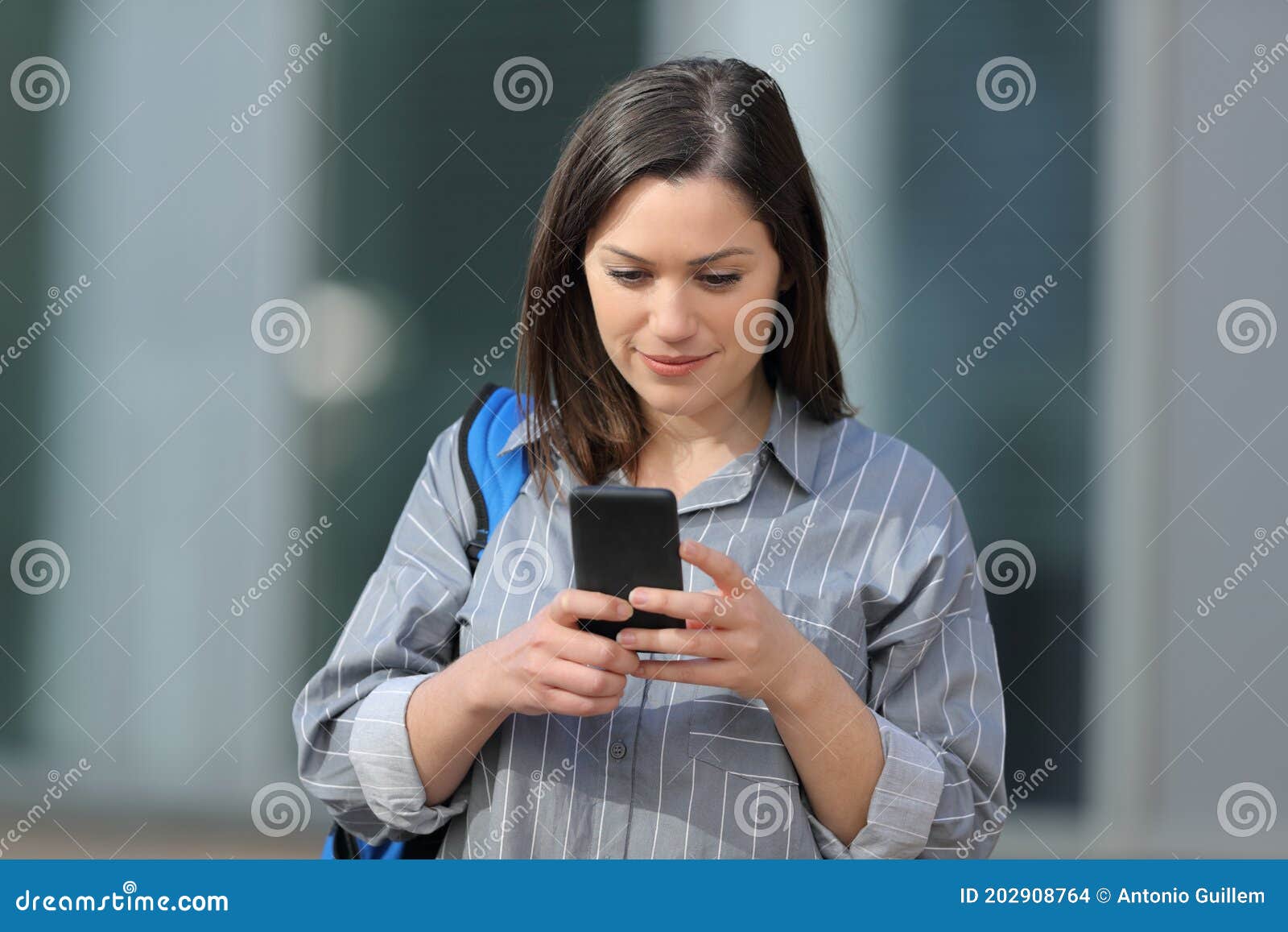 Student Checking Smartphone Walking in a Campus Stock Photo - Image of ...