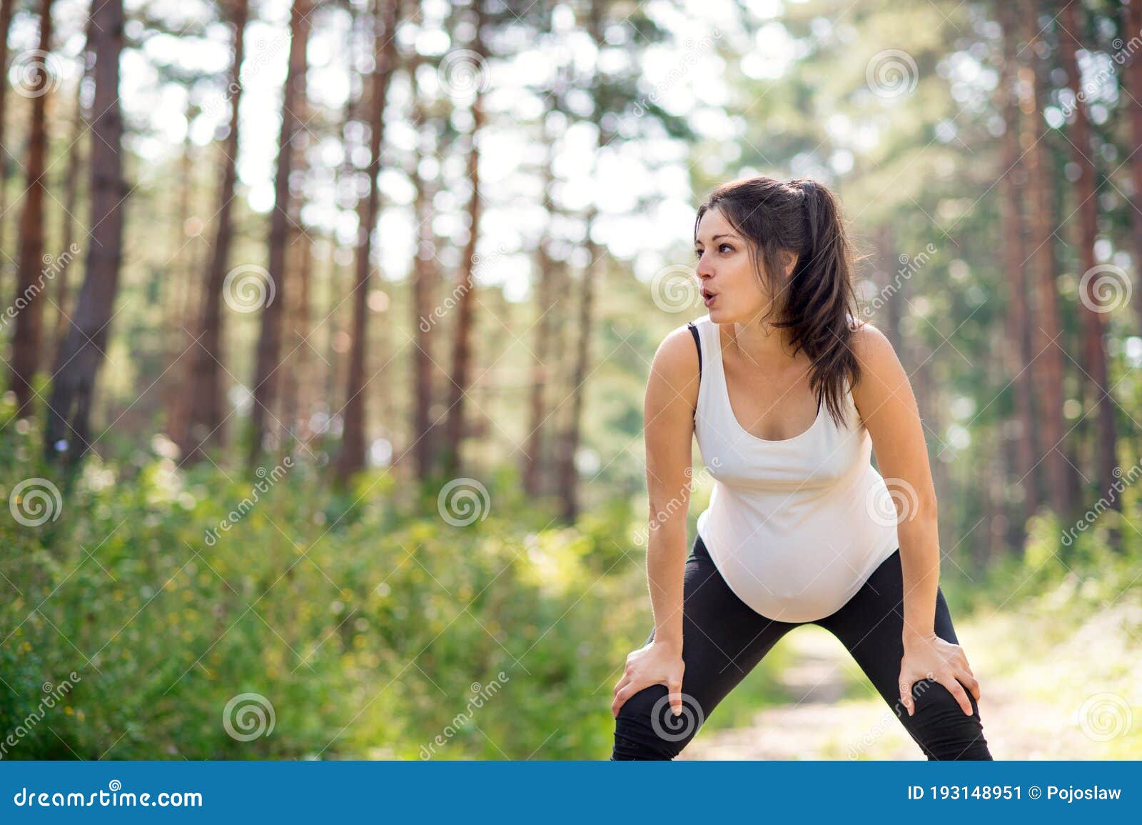 Portrait Of Happy Pregnant Woman Outdoors In Nature Doing Exercise