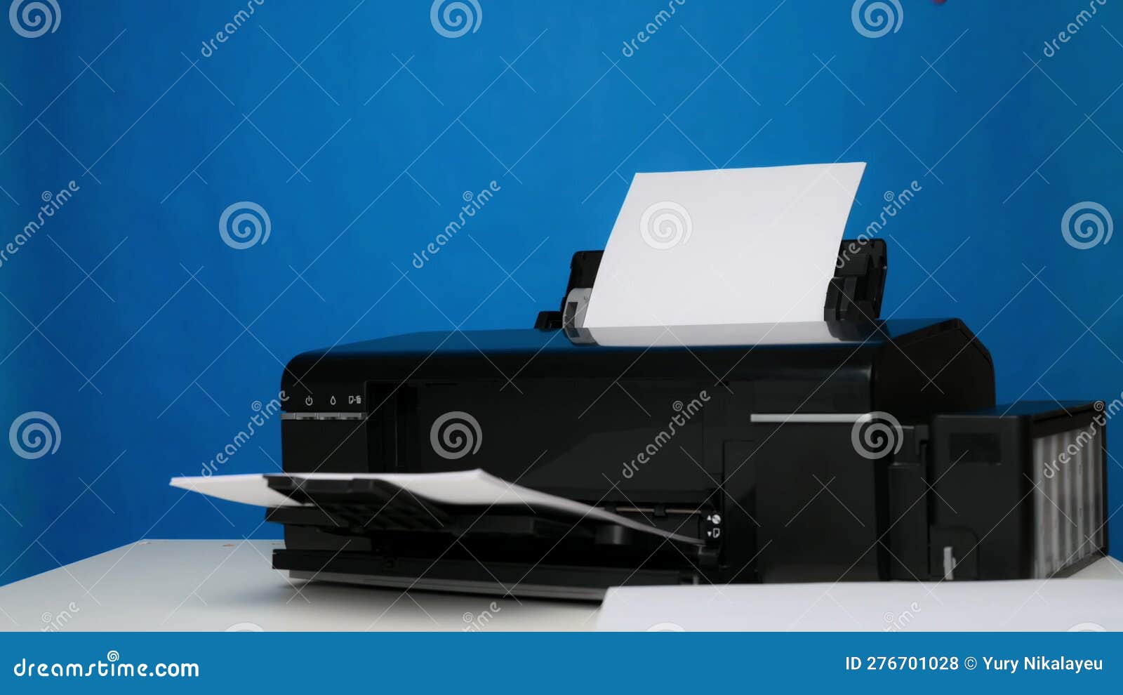 Front View of a Printer and a Blank Sheet of A4 Paper on a Blue ...