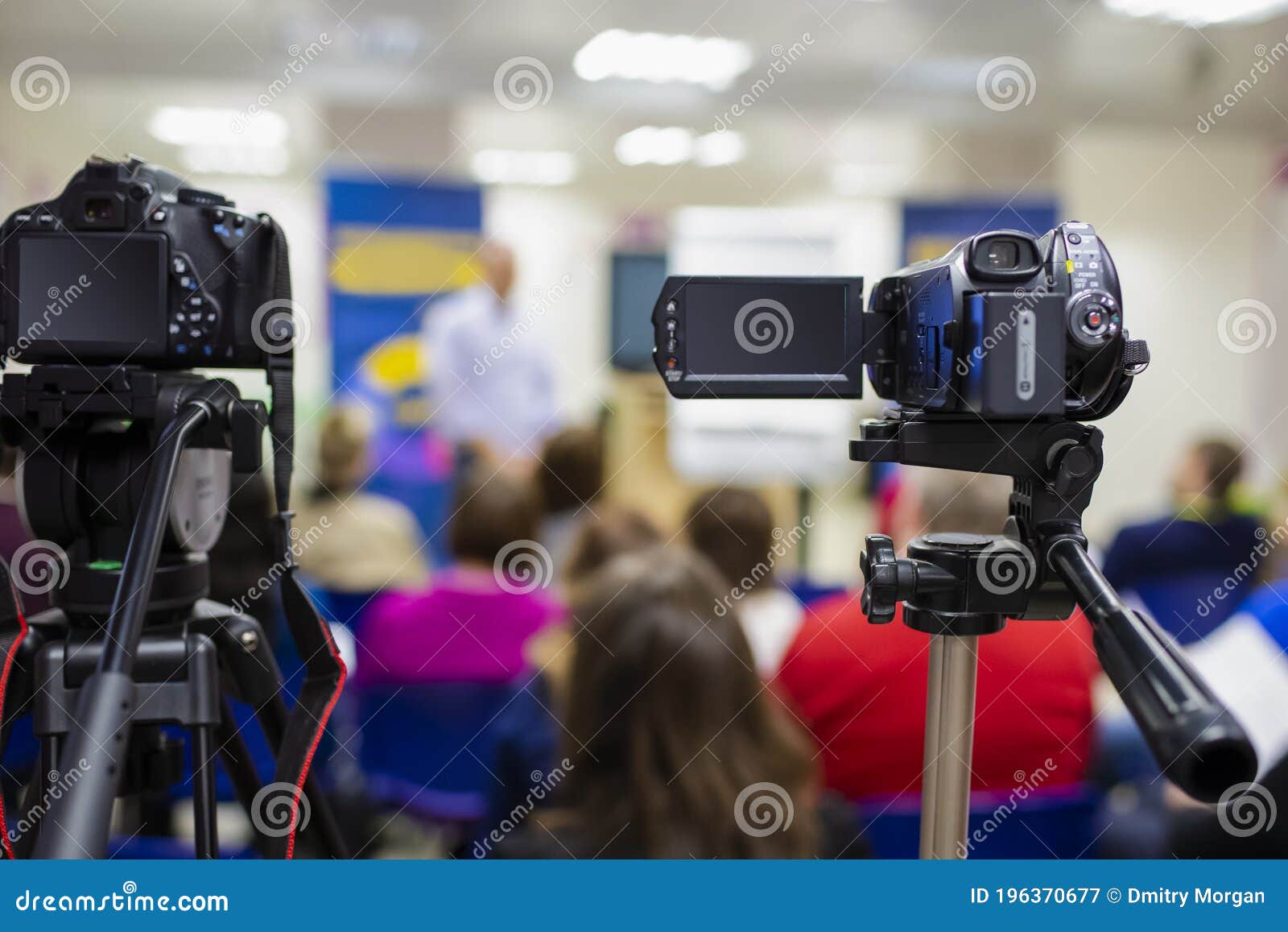 Front View of Professional Videocamera. Positioned Against Blurred ...