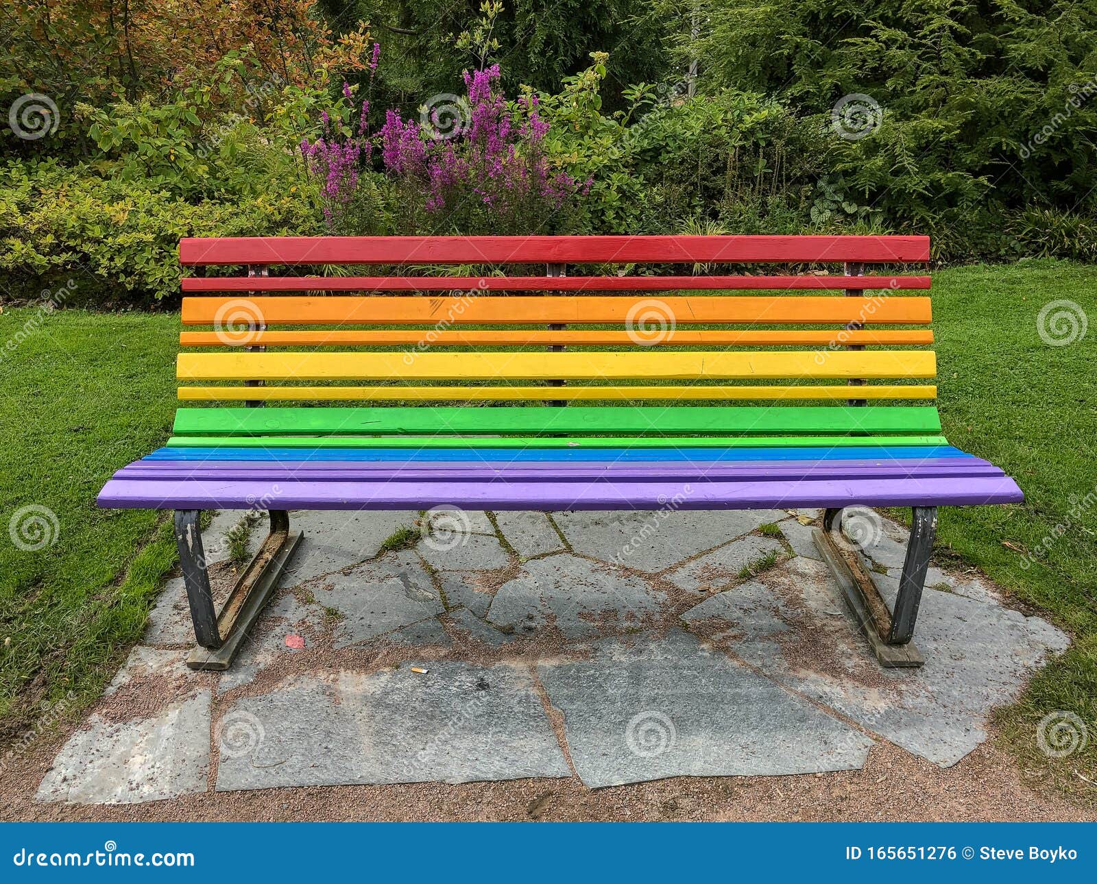 Front View of Rainbow Park Bench on Stone Foundation Stock Photo ...
