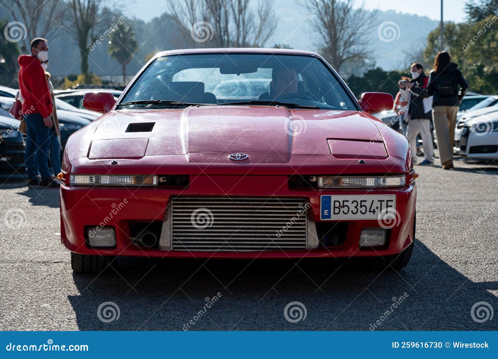 Front View of a Red Third-generation Toyota Supra A70 Car with a Man ...