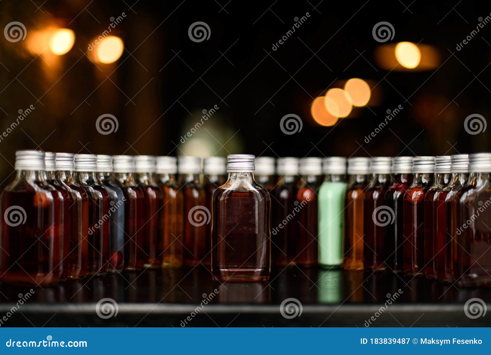 Front View on Row of Bottles with Alcoholic Drinks on Bar Counter ...