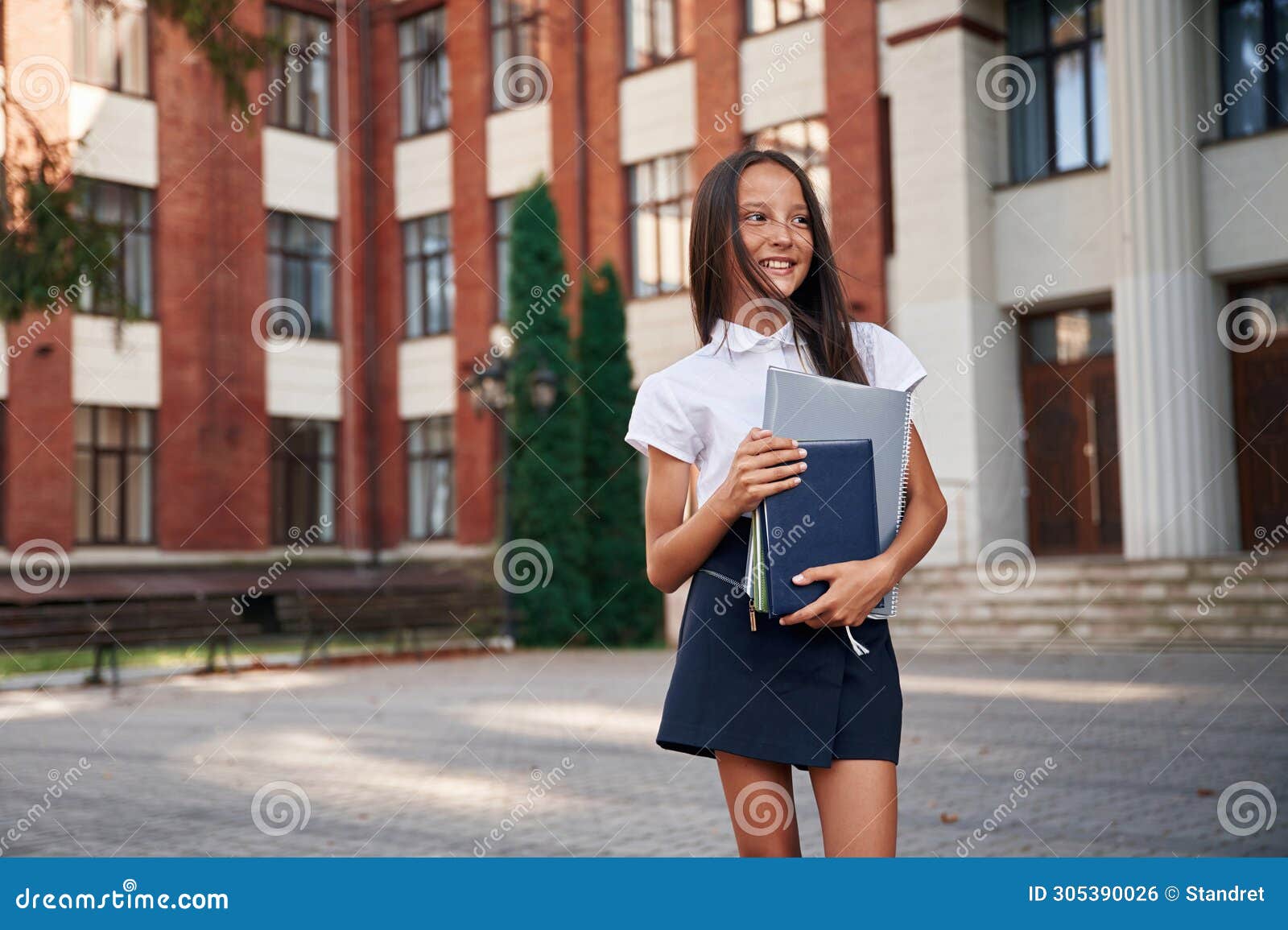 Front View. School Girl in Uniform is Outdoors Near the Building Stock ...