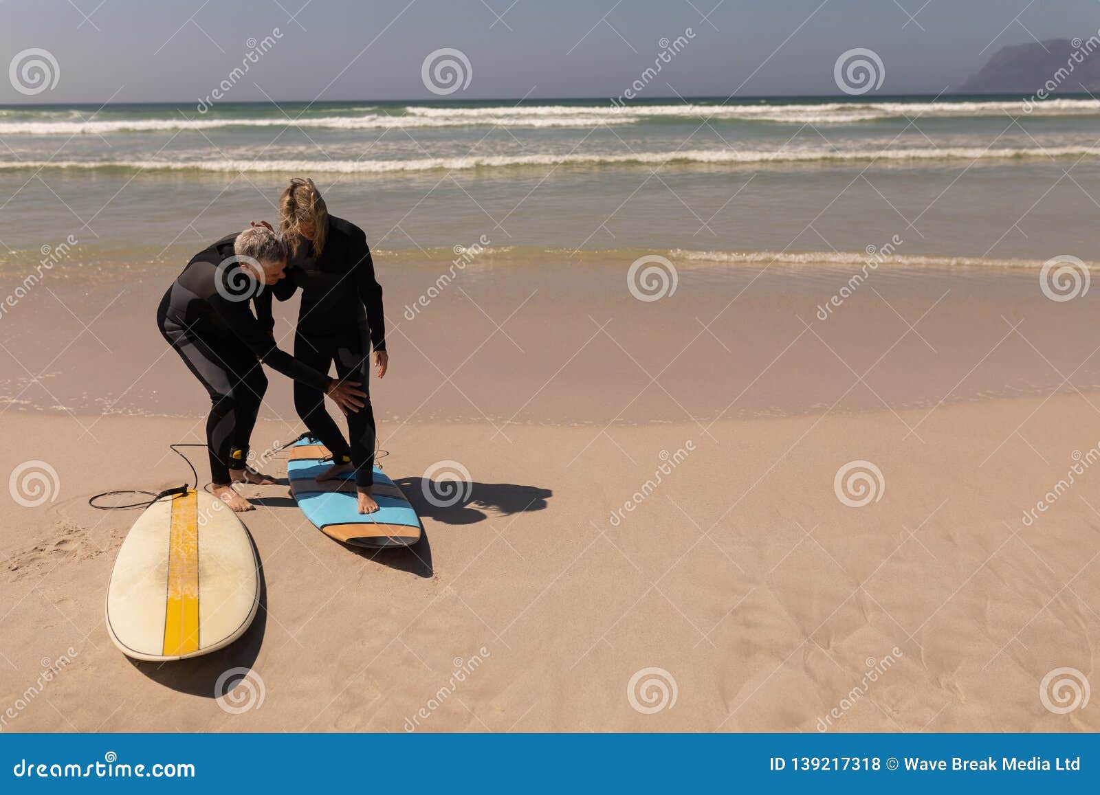 Front View of Senior Surfer Couple Standing with Surfboard on the Beach ...