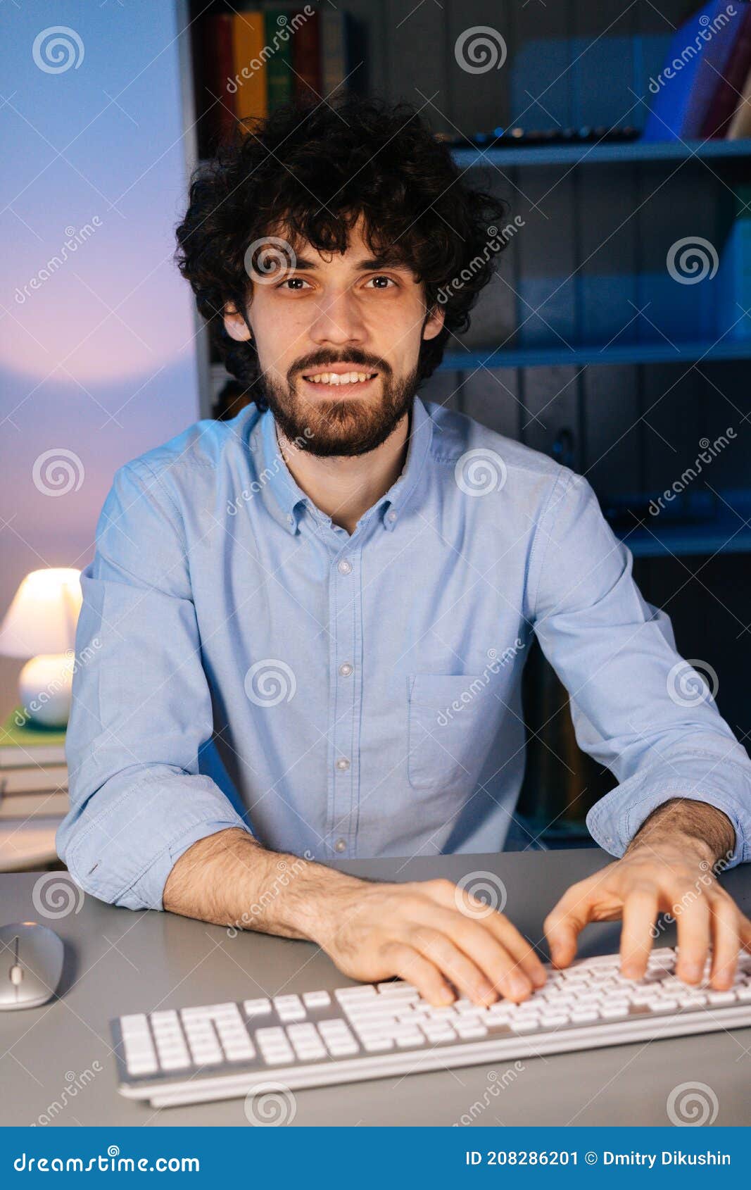 Front View of Smiling Bearded Young Man Looking at Camera and Typing ...