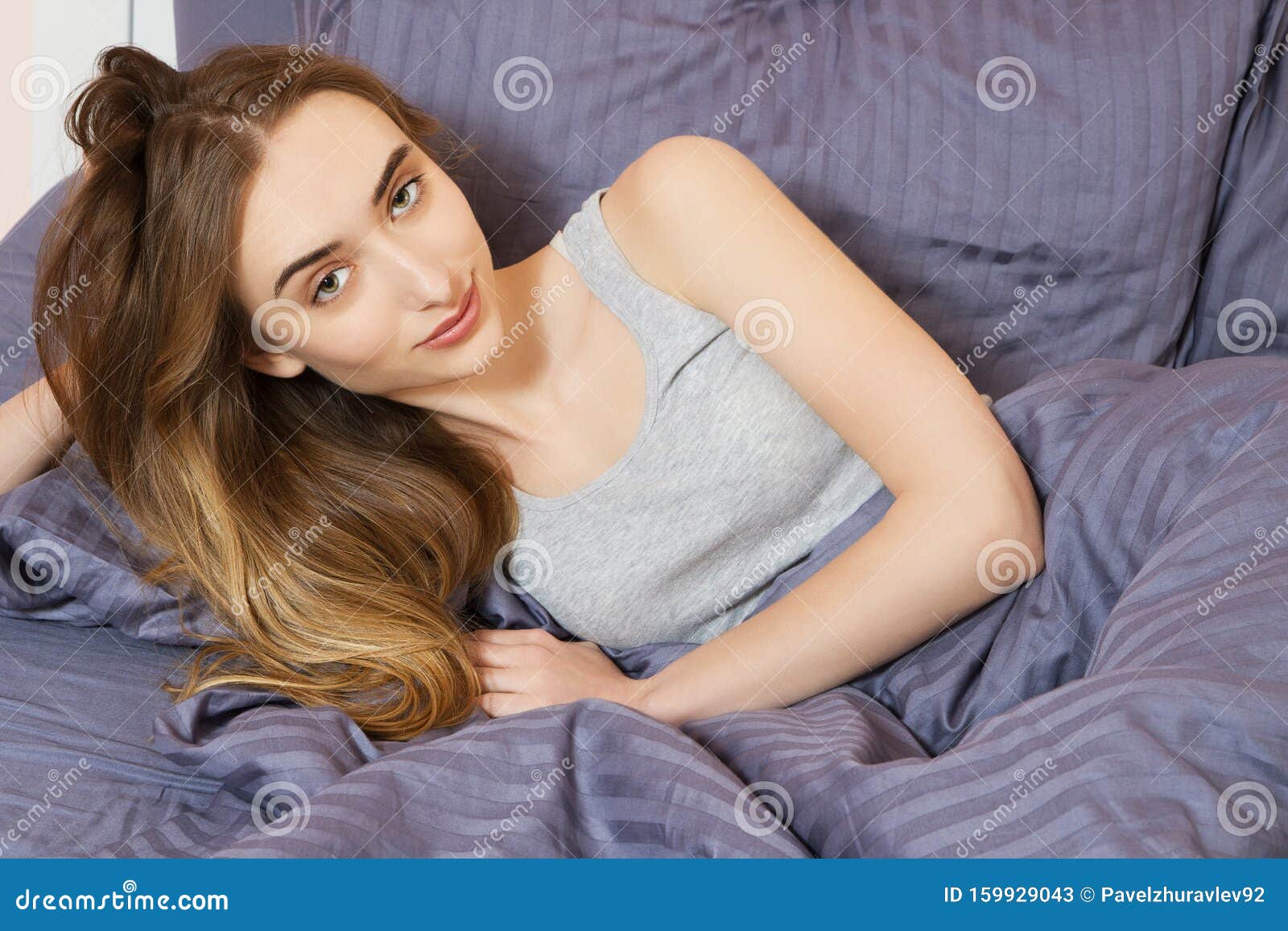Front View of Smiling Modern Woman Waking Up after Sleep on Bed Stock ...