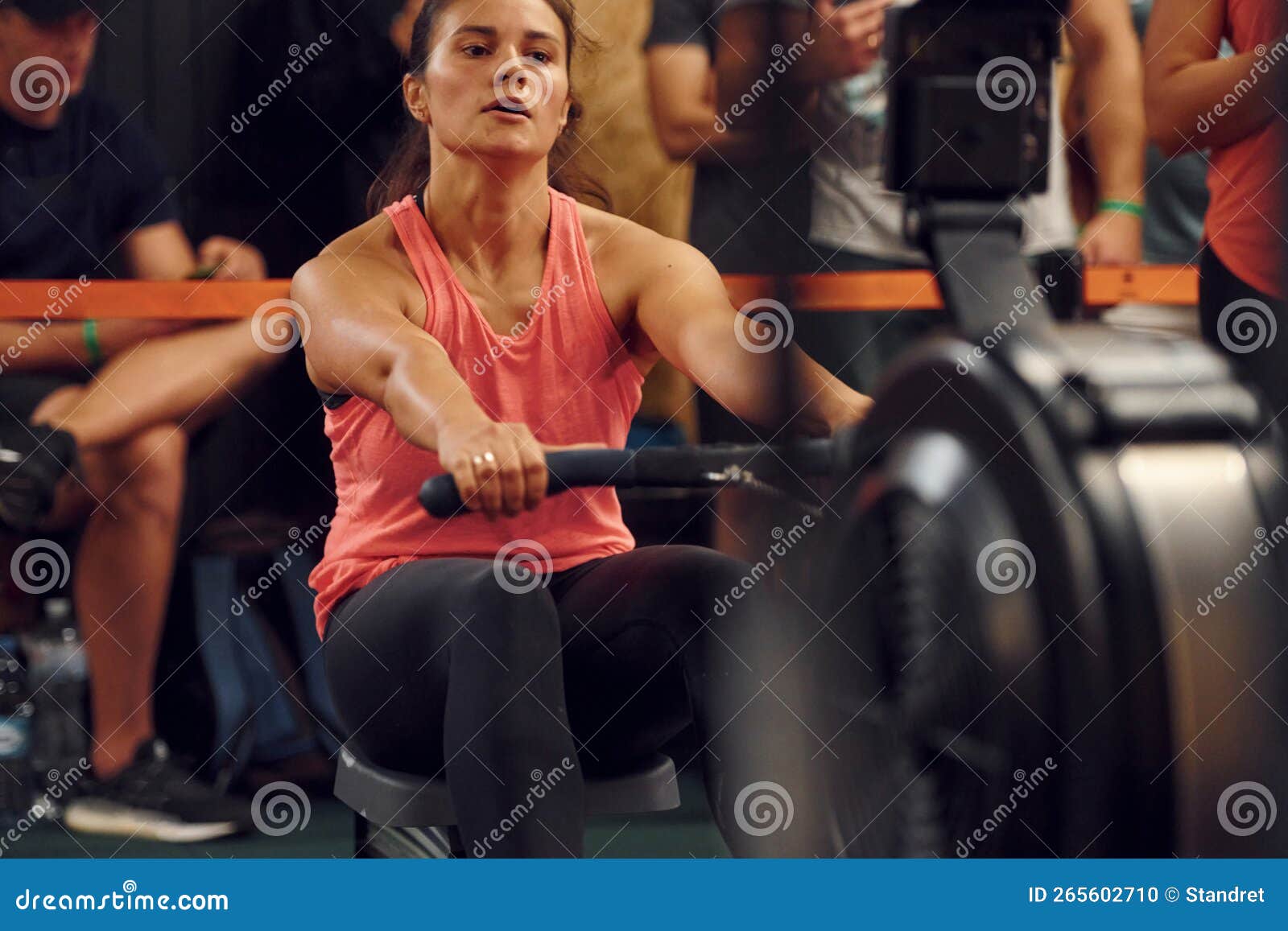 Front View. Sportive Woman Doing Exercises on Rowing Machine in the Gym ...