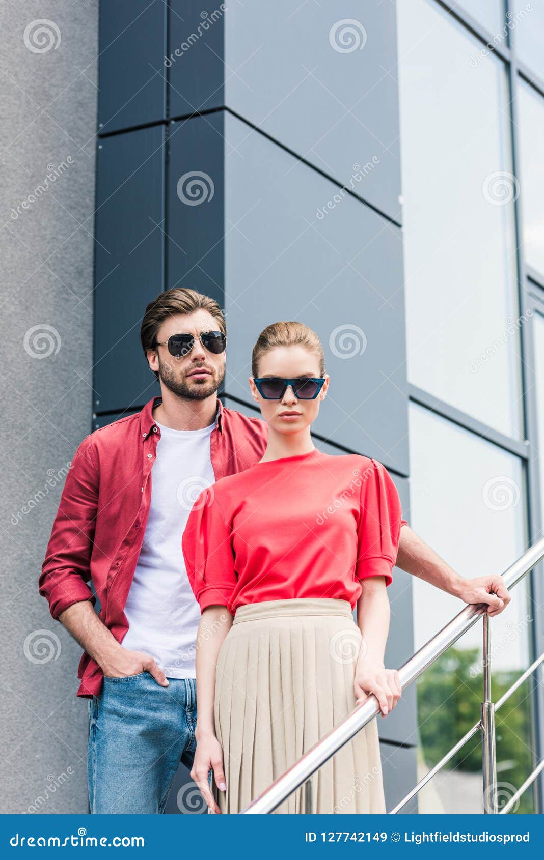 Front View of Stylish Young Couple of Models in Sunglasses Standing ...