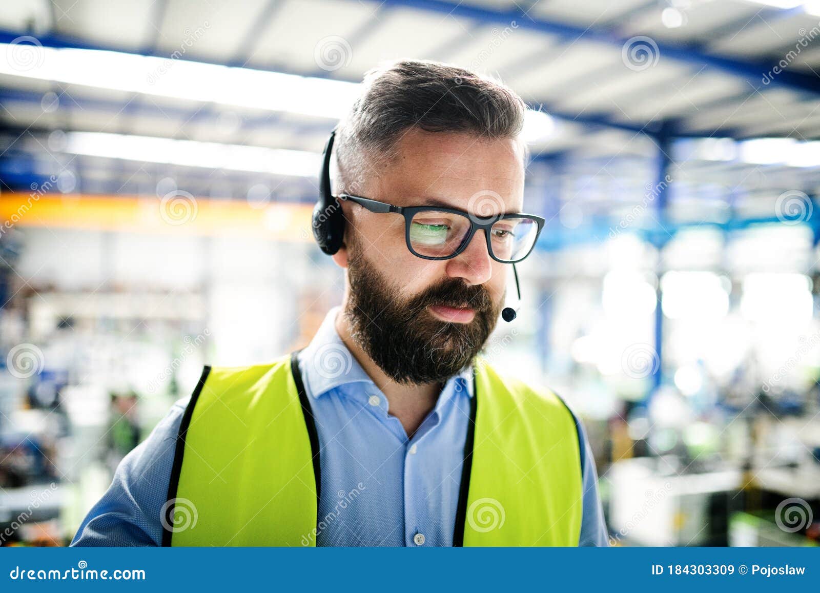 Front View of Technician or Engineer with Headset Standing in ...