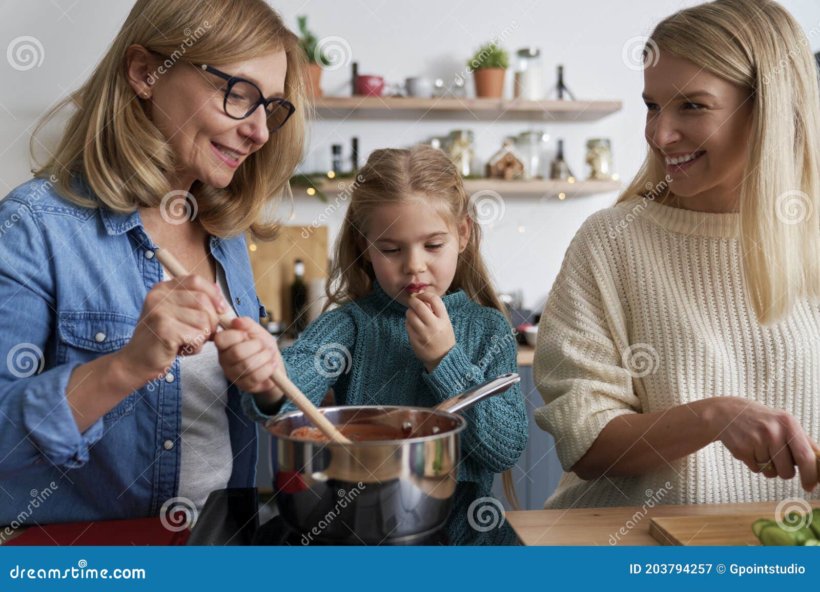Front View of Three Generations Women Cooking in the Kitchen Stock ...