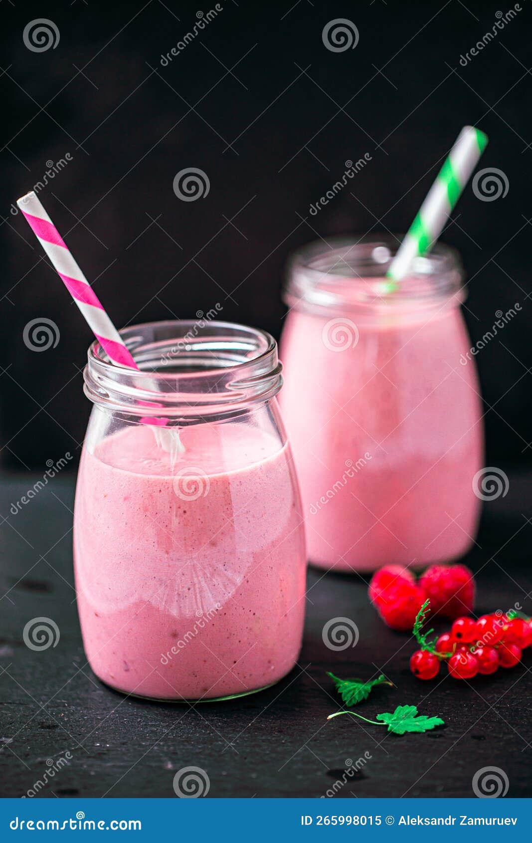 Front View of Two Berries Milkshakes in Glass Jars with Currant and ...