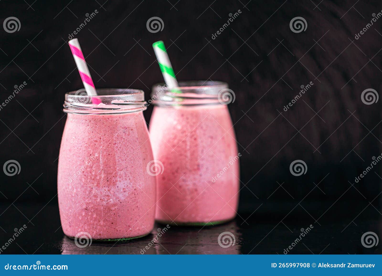 Front View of Two Jars with Yogurt Pink Smoothie with Berries on Black ...