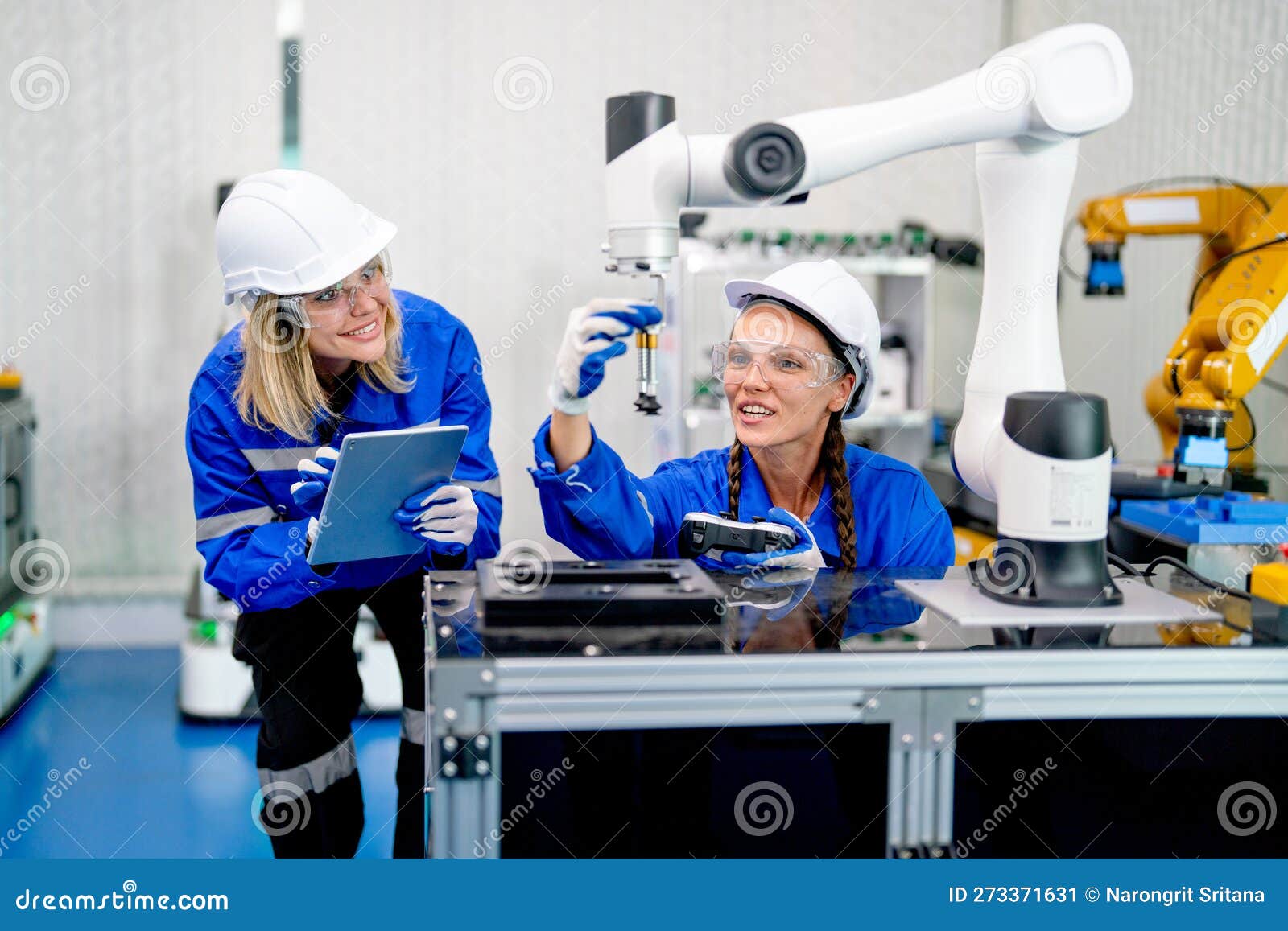 Front View of Two Professional Technician or Engineer Women Sit and ...