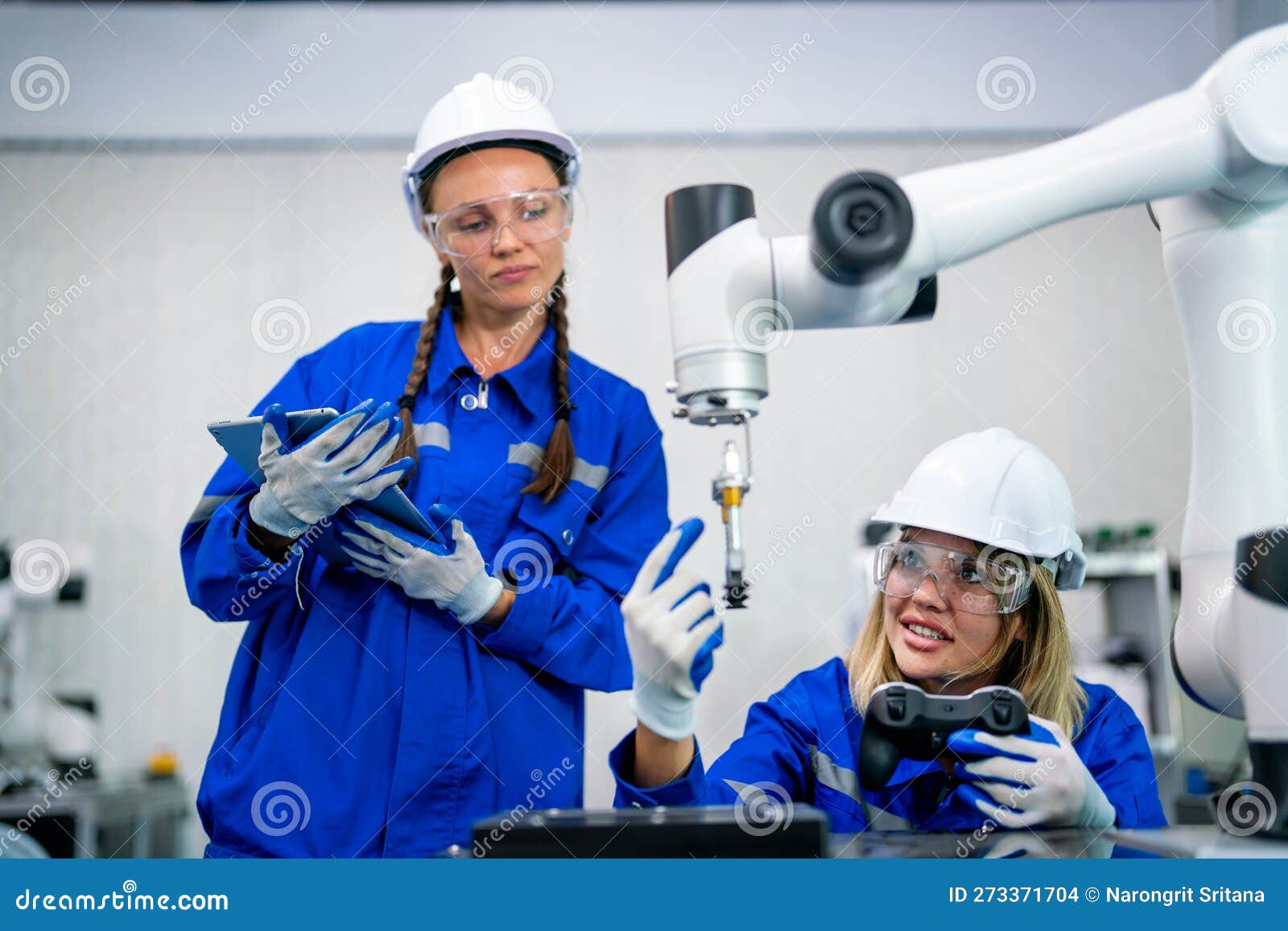 Front View of Two Professional Technician or Engineer Women Sit and ...