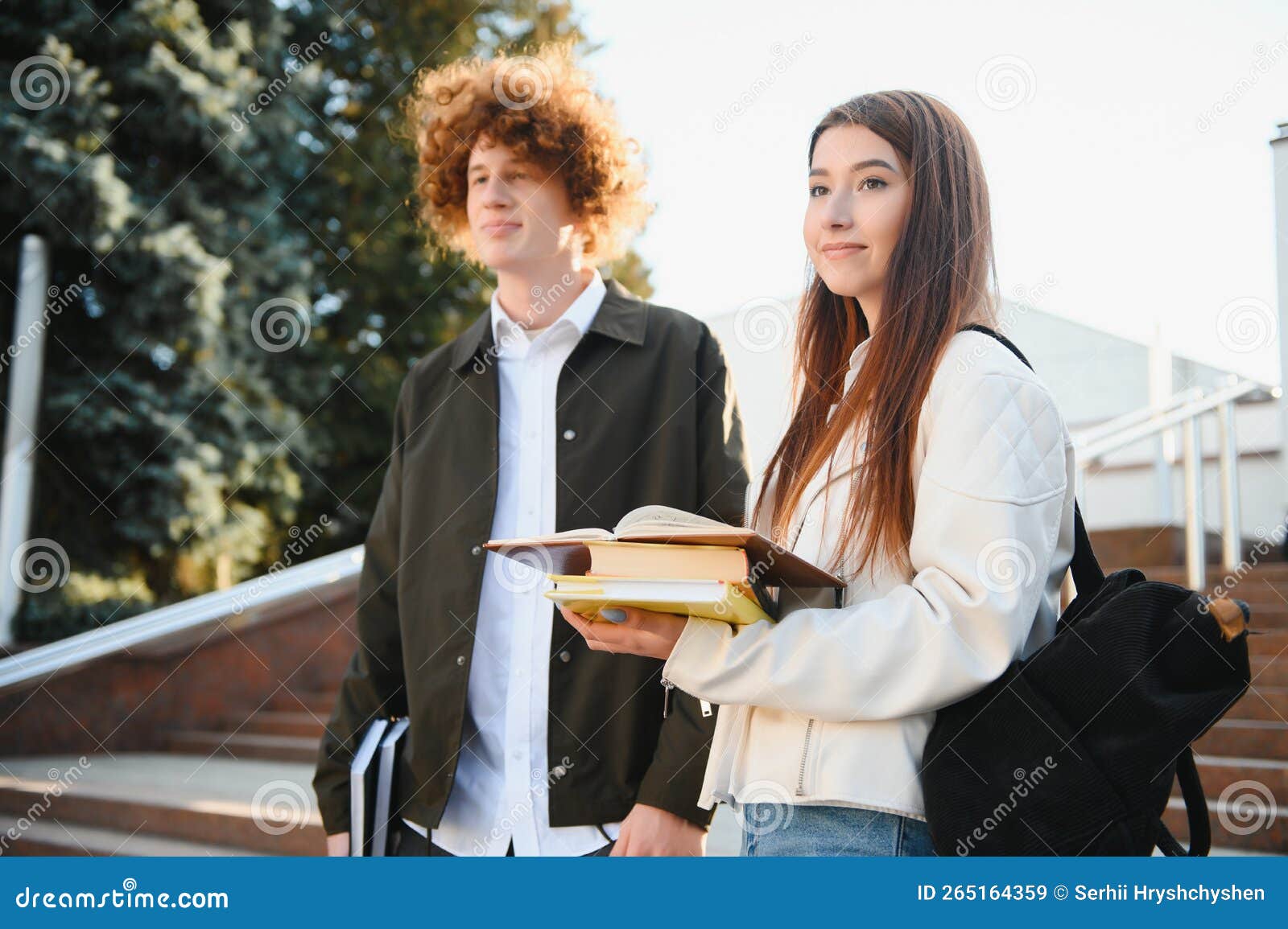 Front View of Two Students Walking and Talking in an University Campus ...