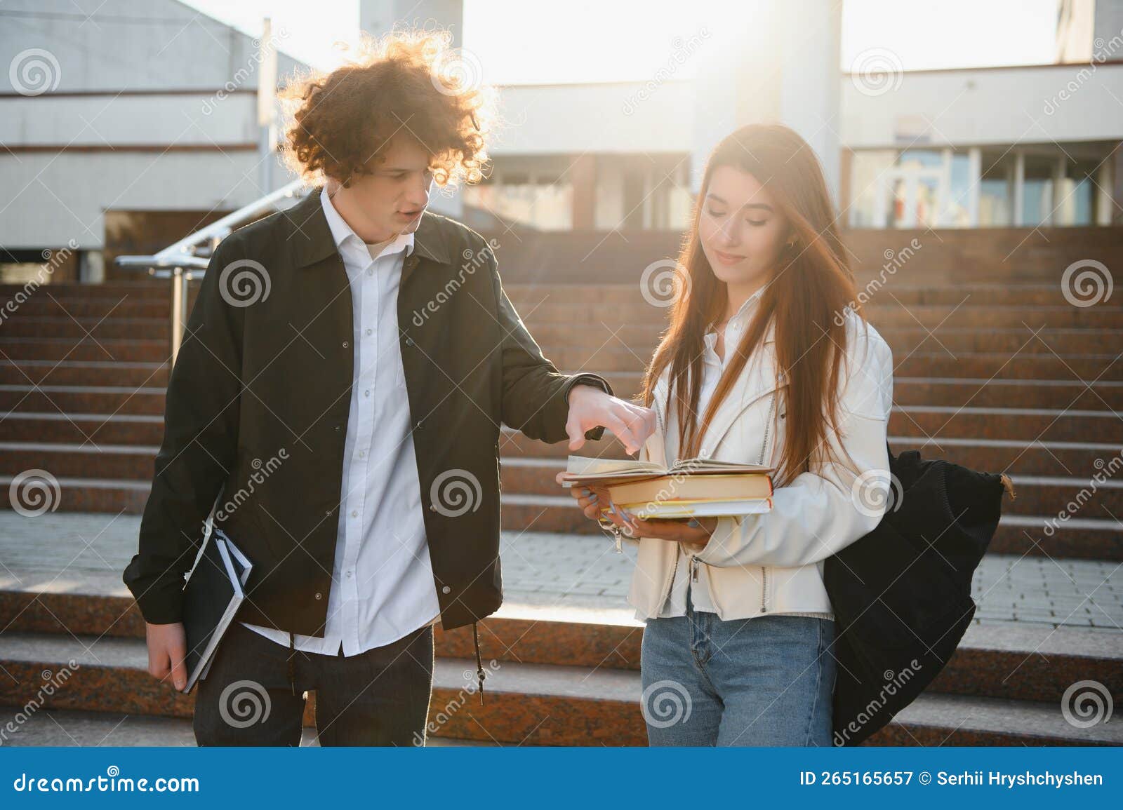 Front View of Two Students Walking and Talking in an University Campus ...