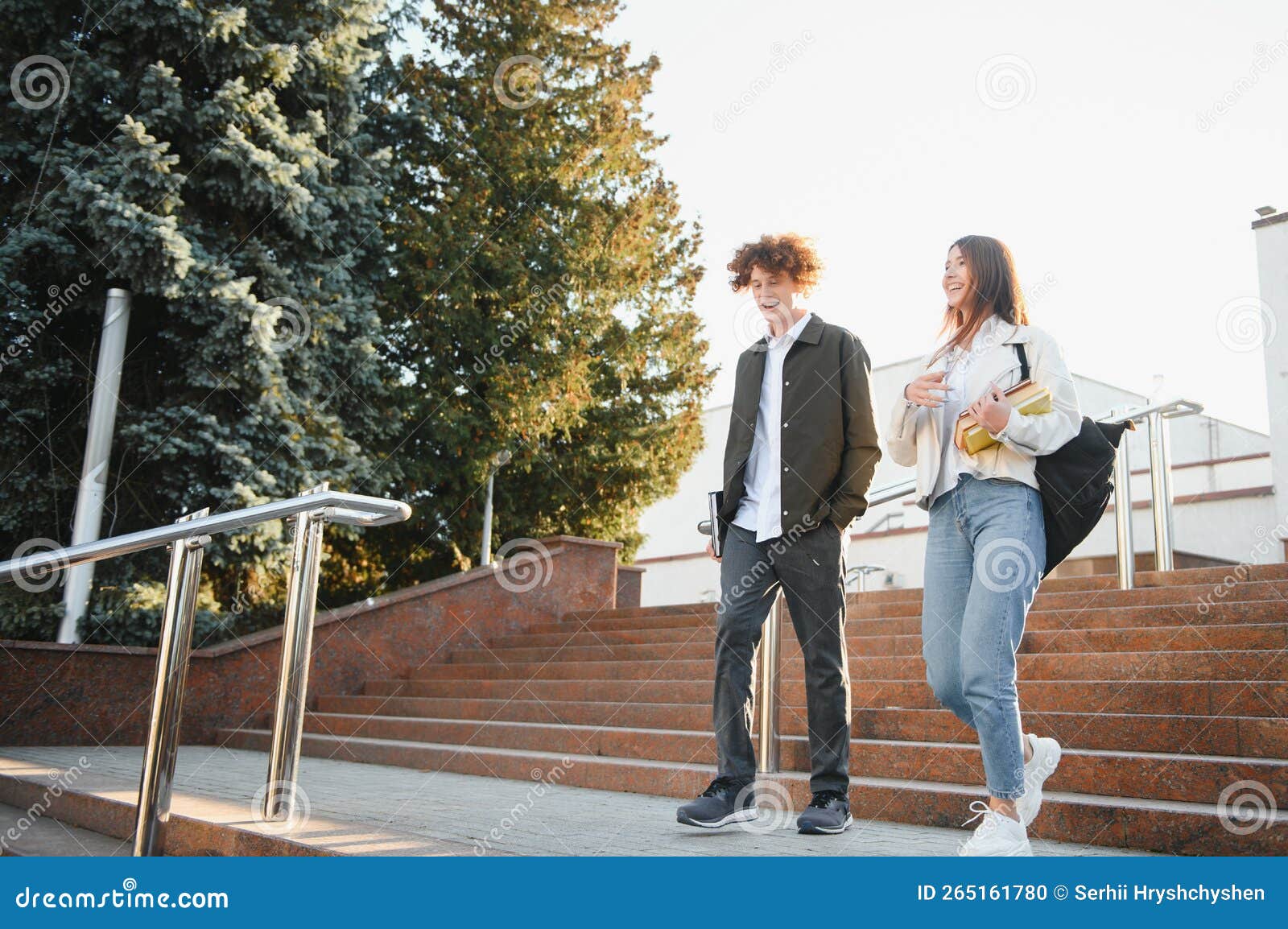 Front View of Two Students Walking and Talking in an University Campus ...