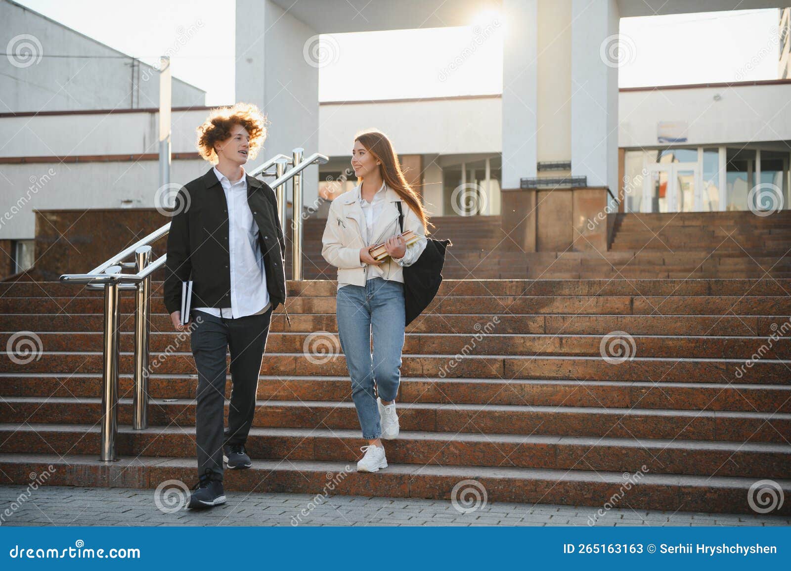 Front View of Two Students Walking and Talking in an University Campus ...