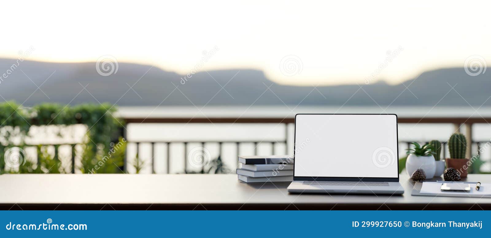 Front View of a Workspace on a Balcony with a White-screen Laptop ...
