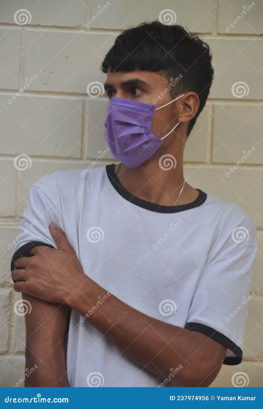 Front View of a Young Guy Wearing Face Mask with Looking Sideways while ...
