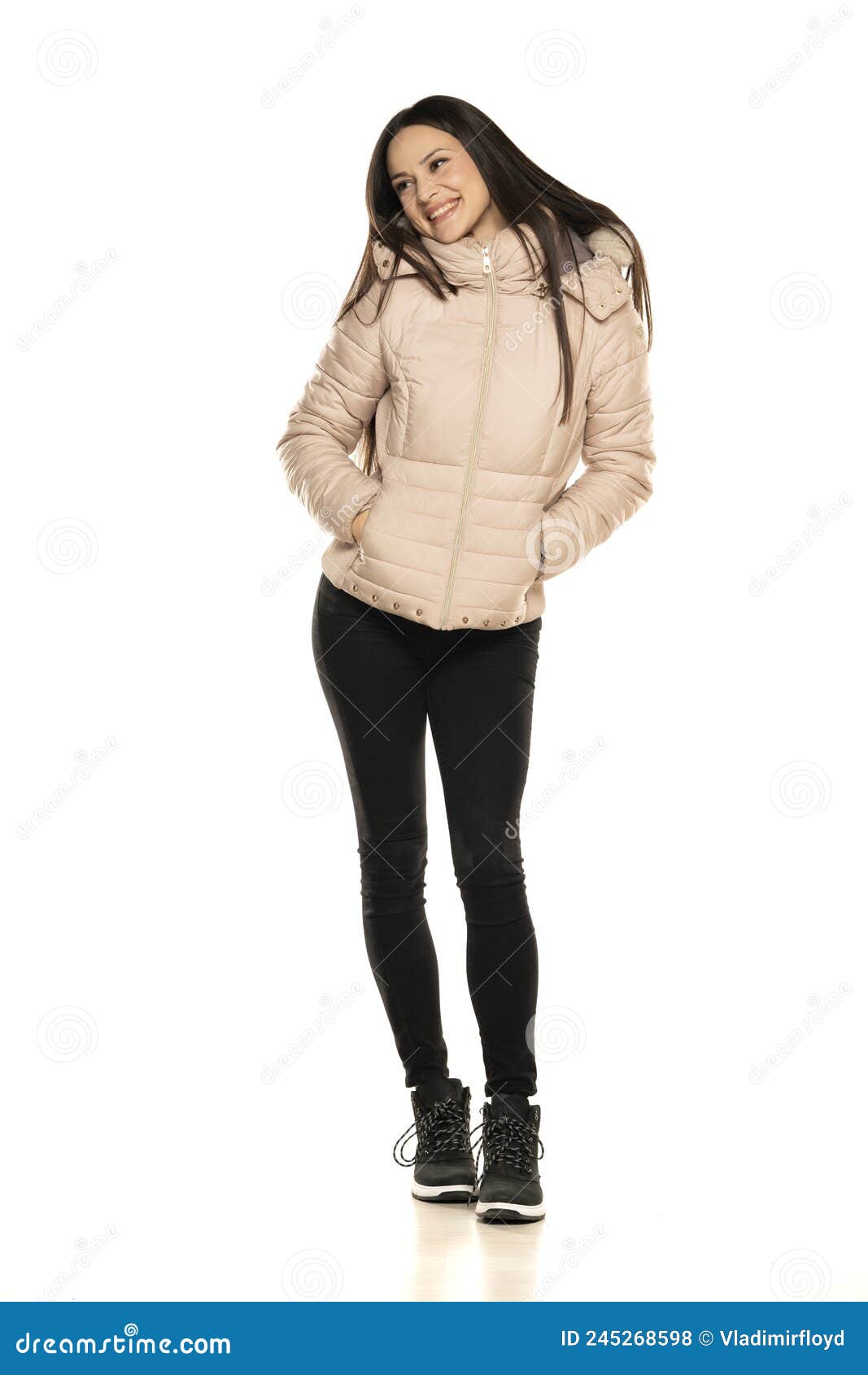 Front View of a Young Woman in Winter Jacket, and Black Jeans Posing on ...