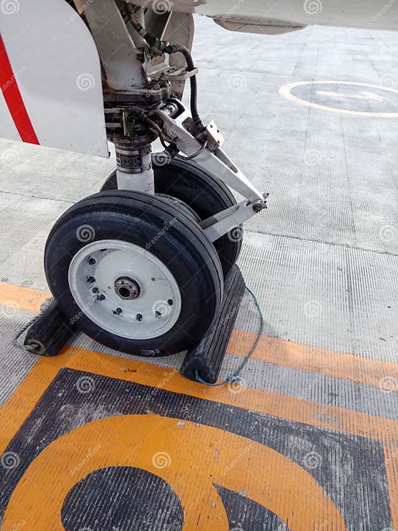 The Front Wheel of an Airplane Parked Editorial Stock Image - Image of ...