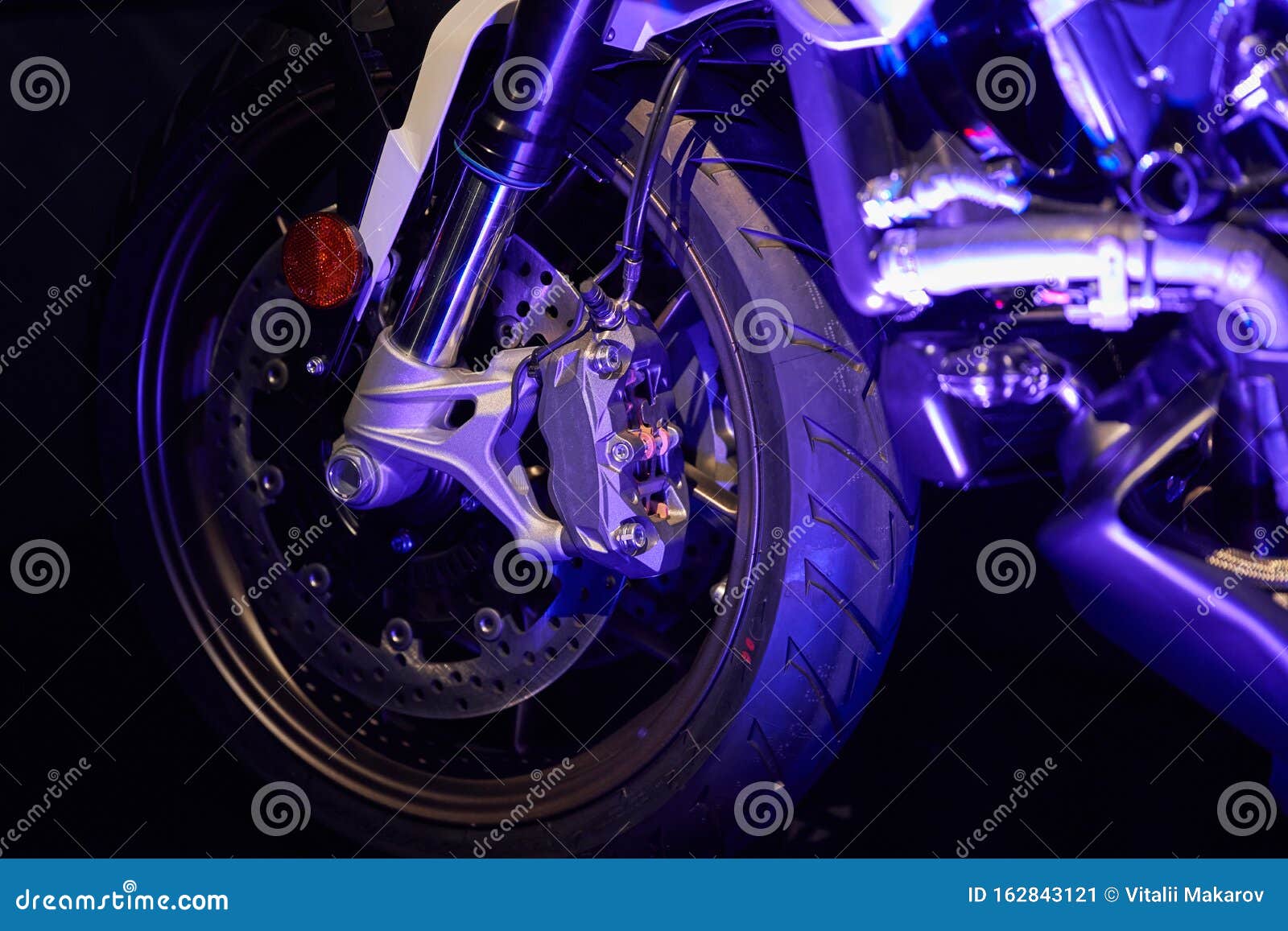 The Front Wheel of a Modern Motorcycle with Blue Lighting. Studio ...