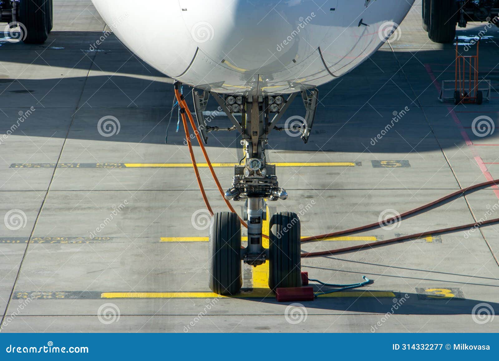 The Front Wheels of an Airplane Parked at the Airport Stock Image ...