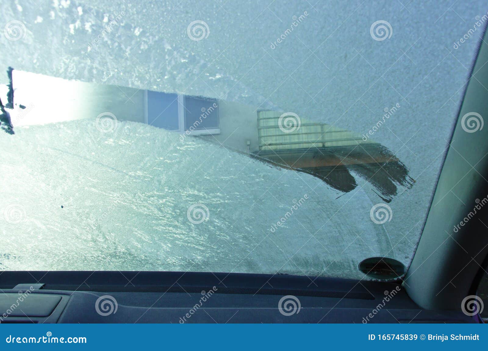 The Front Windshield of a Car is Scraped from the Ice in Winter, Inside ...