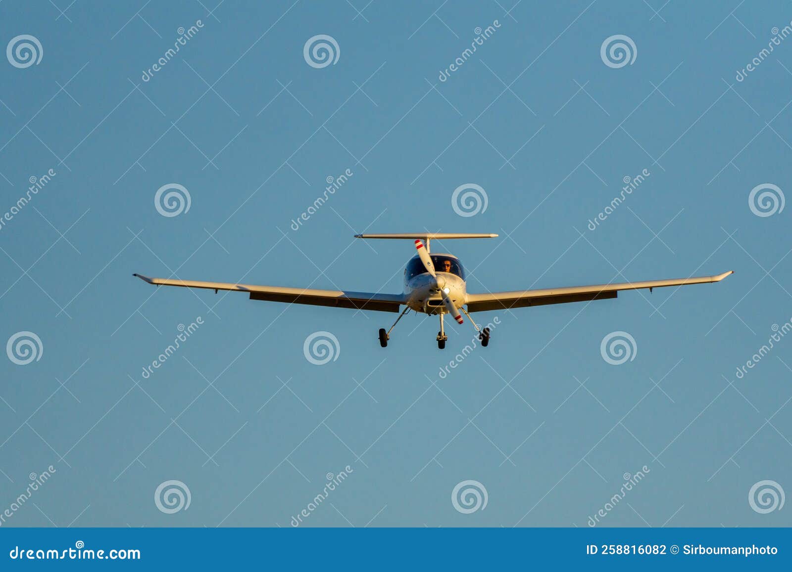 Frontal View of Airplane Approaching the Runway at Sunset Stock Photo ...