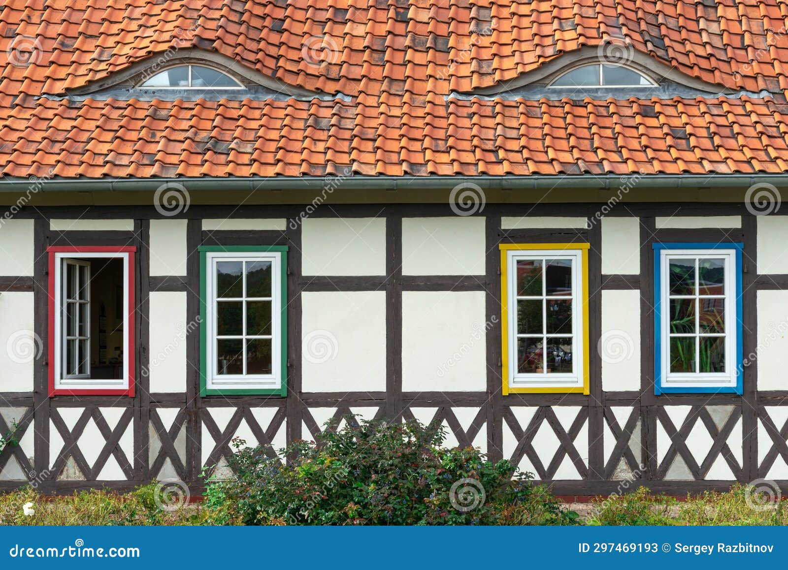Frontal View of a Traditional Half-timbered House with Colorful Windows ...