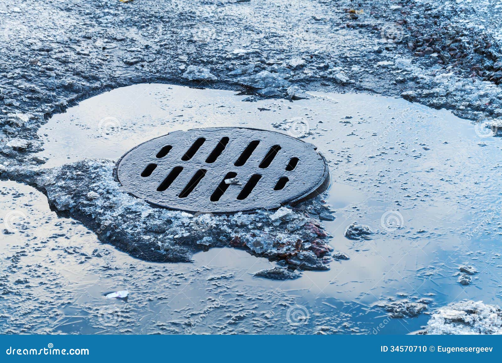 Frosted Puddle with Round Sewer Manhole Stock Photo - Image of frozen ...
