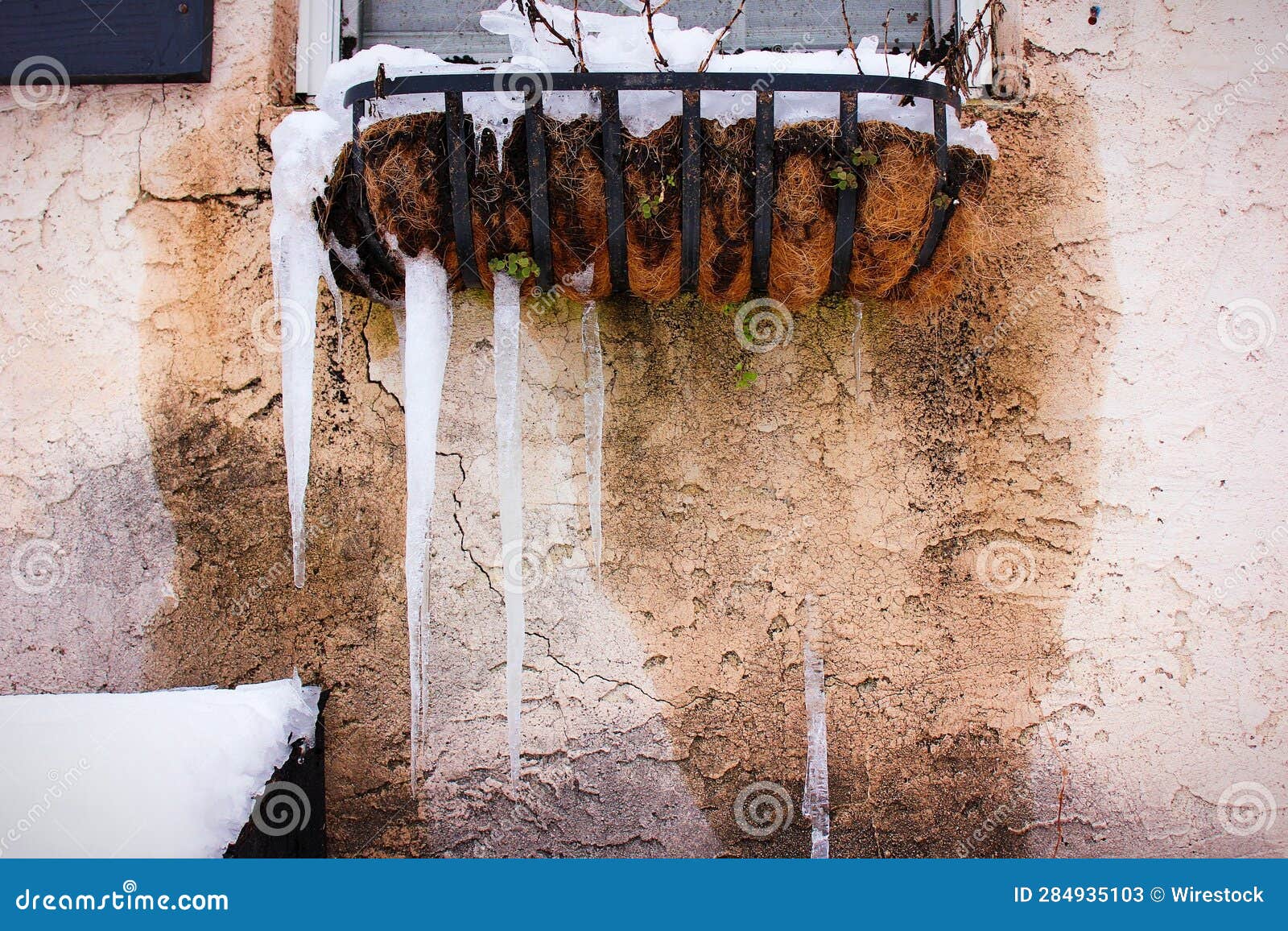 A Window is Covered in Ice As it Grows Out of the Window Frame Stock ...
