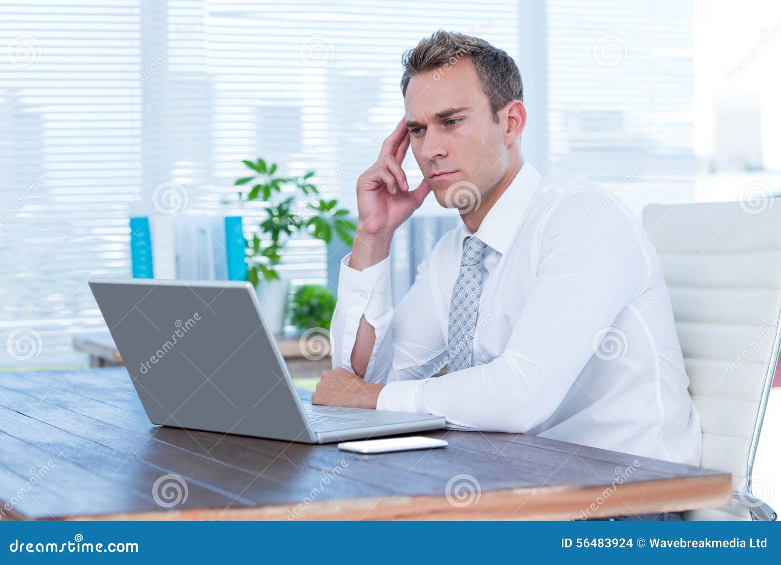Frowning Businessman Looking at His Laptop Stock Photo - Image of ...